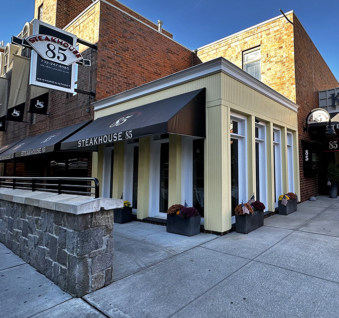 Classic architecture meets modern dining at Steakhouse 85. That awning isn't just navy blue &ndash; it's a promise of excellence.