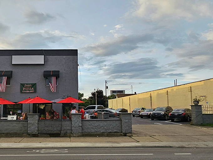 Red umbrellas stand ready at Josie's, protecting precious pizza moments from everything except your unstoppable appetite.
