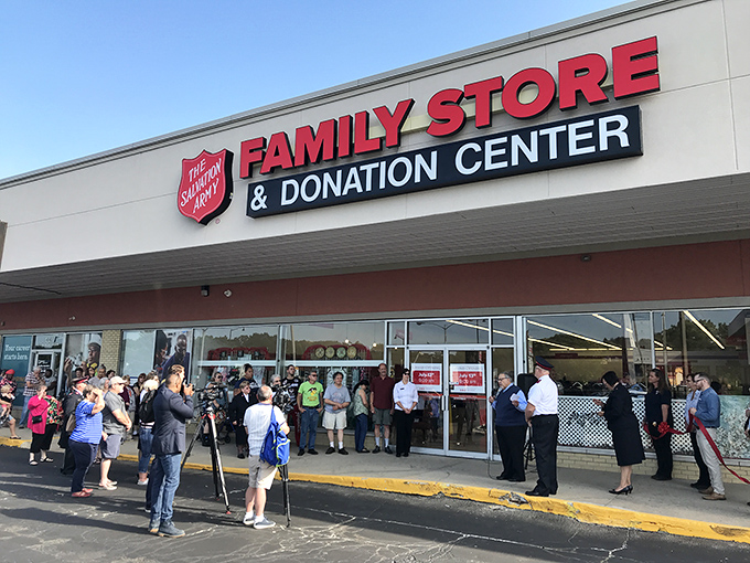 A gathering outside this Salvation Army location suggests a special event &ndash; perhaps a grand opening or community celebration of thrifty goodness.