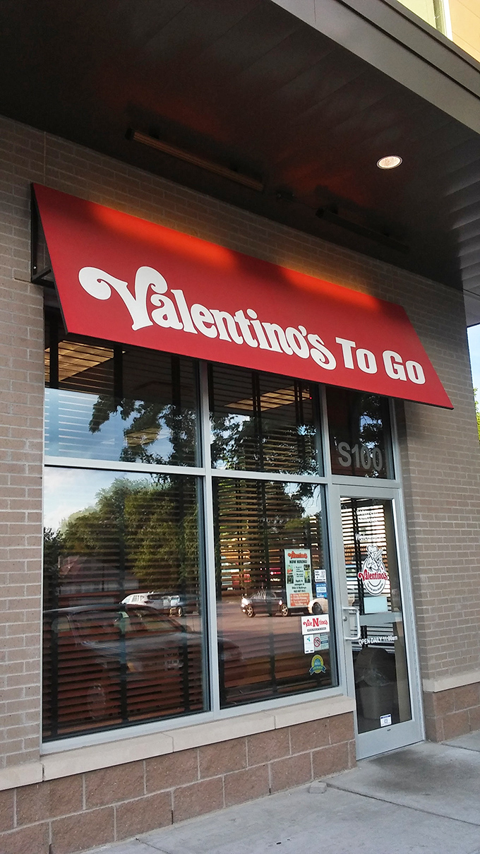 The clean lines of Valentino's storefront hide decades of pizza perfection waiting inside. 