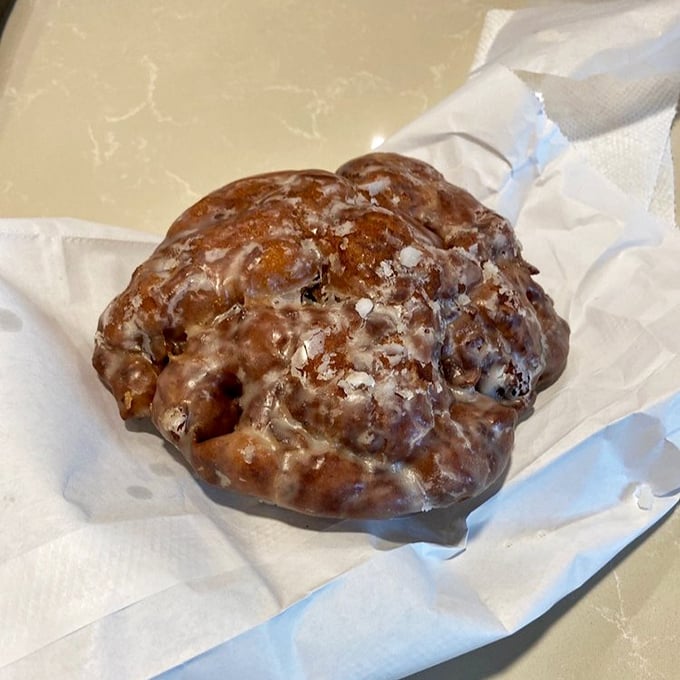 Not just a fritter, but a monument to the apple. This craggy, glazed beauty demands to be eaten with both hands.