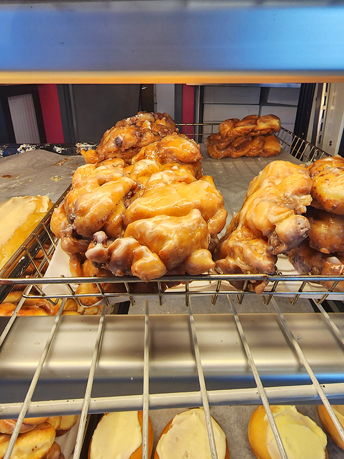 These apple fritters aren't just pastries—they're golden archipelagos of caramelized glory. Each craggy peak harbors pockets of apple treasure.