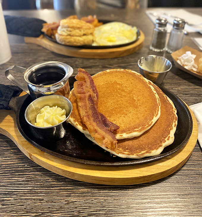 Golden pancakes that look like they were painted by a sunrise artist, served with bacon that's achieved that perfect crispy-yet-tender balance.