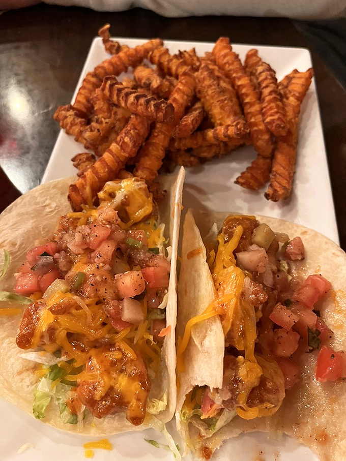 The famous Baja shrimp tacos arrive like edible works of art&mdash;crispy shrimp, fresh toppings, and melted cheese nestled in soft tortillas with a side of curly fries.