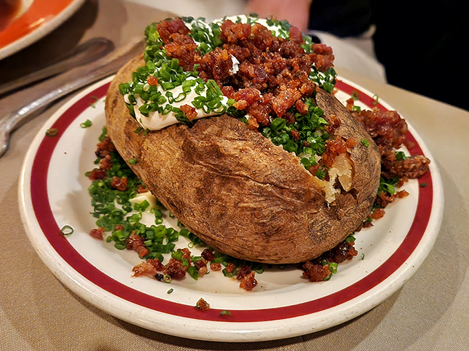 Not just any baked potato&mdash;this loaded beauty comes dressed for dinner with all the fixings, ready for its supporting role in the meat symphony.