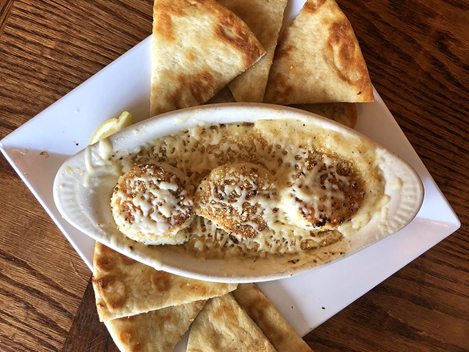 Baked scallops swimming in creamy alfredo with flatbread standing by, ready for the inevitable "I need to soak up every last drop" moment.