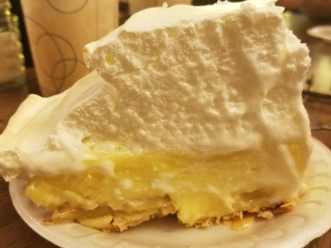 A slice of banana cream pie that would make your grandmother both proud and jealous &ndash; cloud-like meringue floating above golden custard.