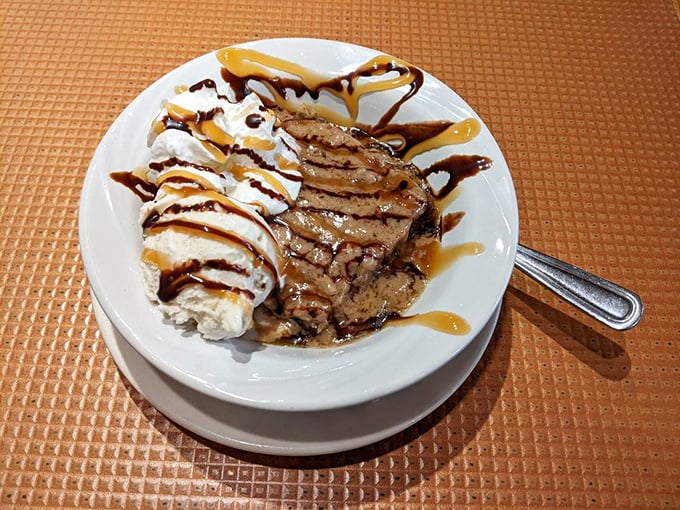 The banana walnut bread pudding arrives looking like the dessert equivalent of a warm hug, drizzled with caramel that means business.