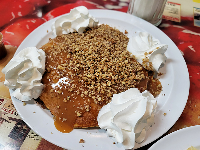 These pancakes aren't just topped with nuts &ndash; they're wearing a crown fit for breakfast royalty, complete with whipped cream courtiers.