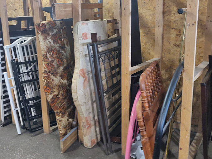 Headboards and bed frames lean like sleeping giants against the wall, waiting for someone to imagine them in a second-life bedroom makeover.