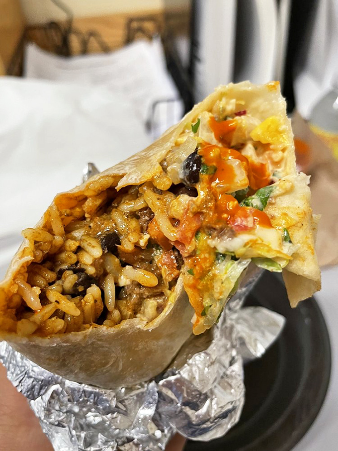 The beef burrito in its natural habitat—perfectly grilled tortilla revealing a glimpse of the treasure within. Food photography or modern art? Both.
