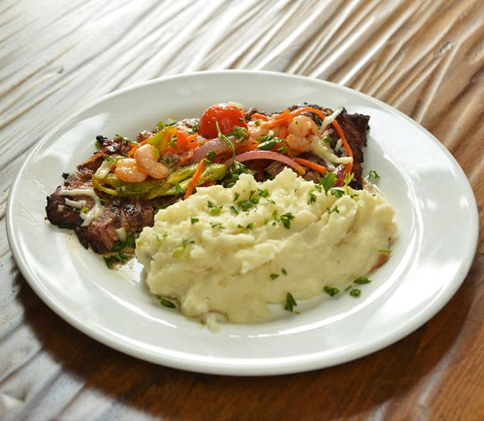 The Bistek Especial brings the drama&mdash;tender steak sharing the spotlight with colorful vegetables and mashed potatoes that deserve their own standing ovation.