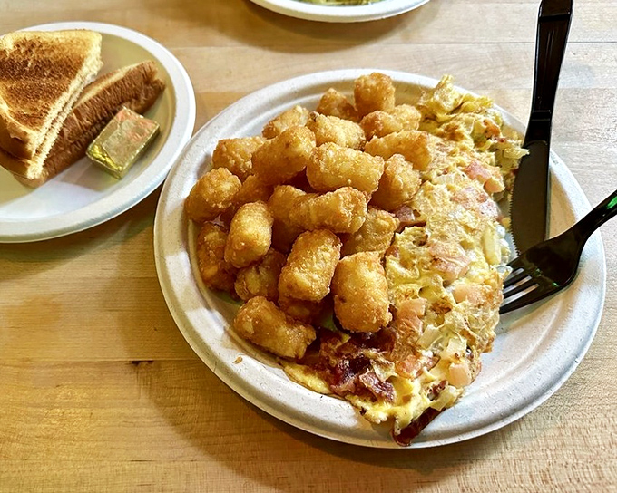 Breakfast doesn't need to wear a tuxedo to impress. This hearty omelette and golden tots combo is morning comfort in its purest form.