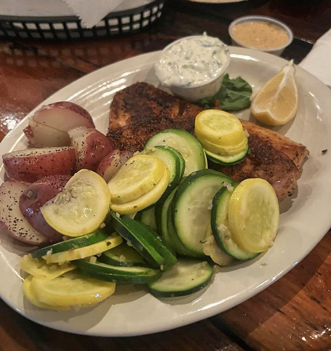 Blackened mahi that doesn't hide behind heavy sauces, accompanied by fresh vegetables and red potatoes that respect the fish's starring role. 