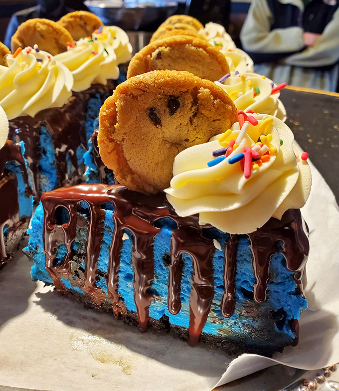 Blue Monster cheesecake with cookie garnish – proof that sometimes the most photogenic foods also deliver the most memorable flavors.