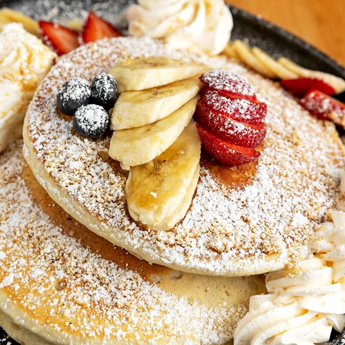 These pancakes aren't just breakfast, they're an edible art installation with fruit that somehow looks both healthy and decadent simultaneously.