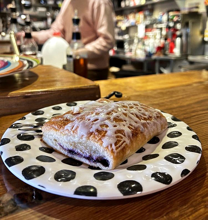 Not your average pastry! This glazed blueberry danish on its polka-dotted plate is what breakfast dreams are made of&mdash;sweet, tart, and utterly irresistible.