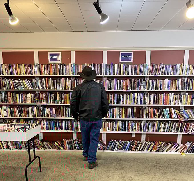 The fiction section rivals small-town libraries. This gentleman knows the best adventures cost just a fraction of retail here.