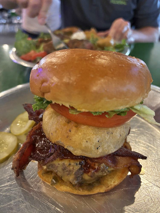 This burger stands tall and proud, like a Texas skyscraper. The perfect architecture of meat, cheese, bacon, and fresh veggies between golden buns.