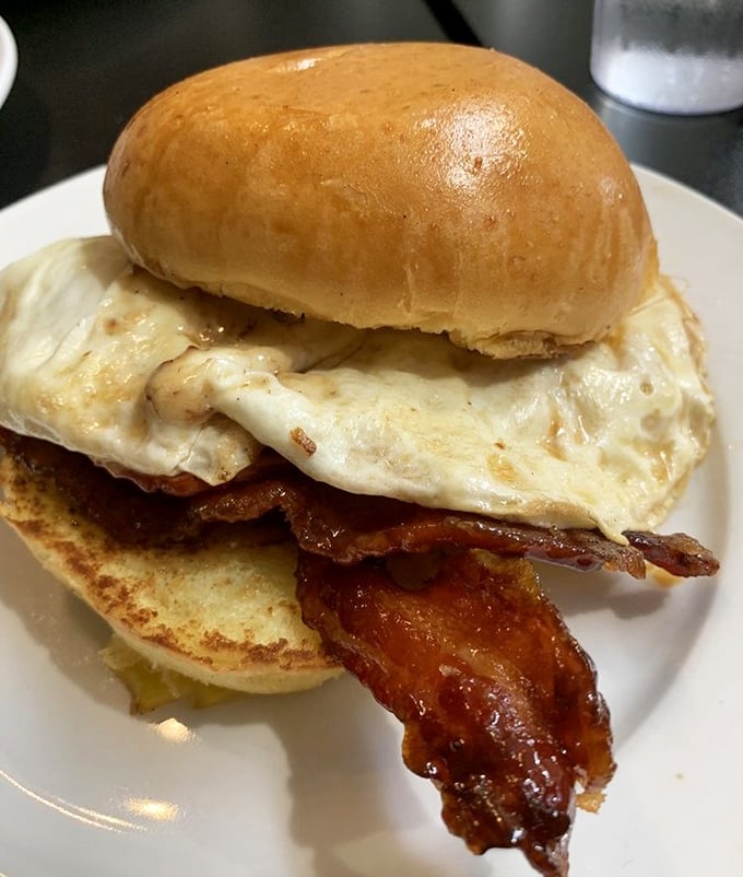 Breakfast architecture at its finest: crispy bacon and a perfect egg on a brioche bun&mdash;proof that mornings can indeed be something to celebrate.