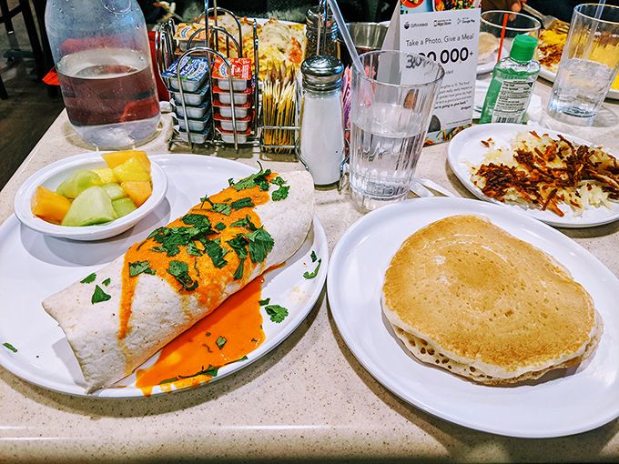 The breakfast spread of champions: a cheese-smothered burrito alongside golden pancakes. This isn't a meal—it's a declaration that today is going to be excellent.