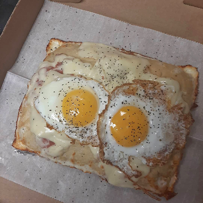 Breakfast pizza: the innovation nobody asked for but everybody needs. Two sunny eyes staring up at you from a bed of melted cheese.