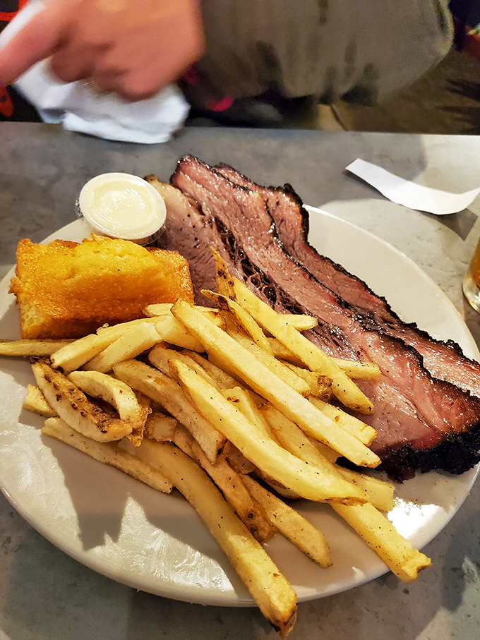 Brisket that speaks the universal language of smoke and patience. Those perfectly seasoned slices represent hours of low-and-slow dedication that you taste in seconds.