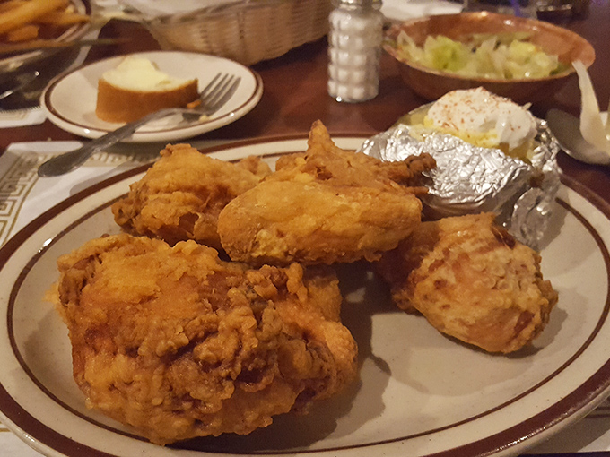 Broasted chicken with golden armor that shatters with each bite, revealing juicy meat within. Colonel who? This is the real Kentucky-adjacent fried chicken glory.