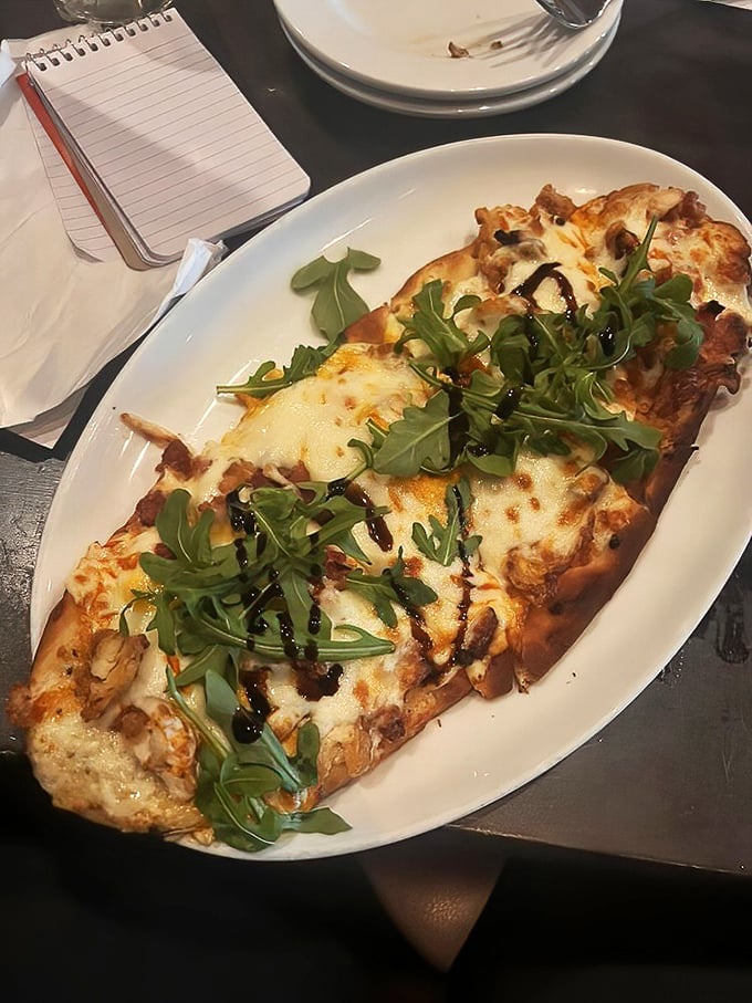This flatbread isn't just a meal; it's a melty masterpiece where buffalo chicken meets arugula in a romance hotter than a New England summer.