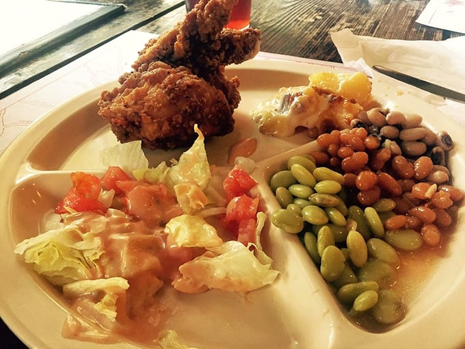 A plate that tells the story of the South: fried chicken, lima beans, pinto beans, and a side salad that somehow makes you feel virtuous while indulging.