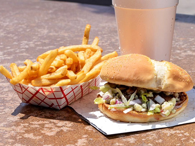 The classic combo that launched a thousand food dreams: a perfectly proportioned burger alongside fries that demand to be savored one by one.