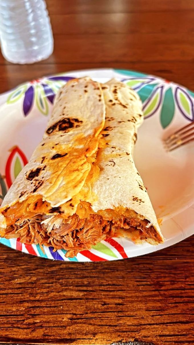 The carne adovada burrito—where chile-marinated pork meets handmade tortilla—is New Mexico's answer to "What's the meaning of life?"