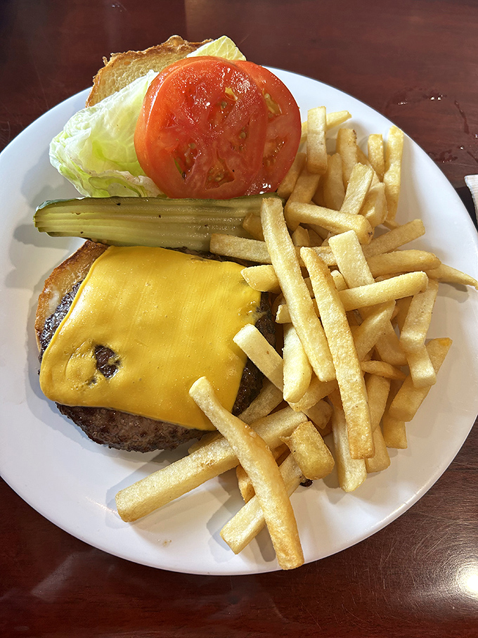 A proper diner cheeseburger should require both hands and several napkins. This beauty checks all the boxes and throws in perfectly crisp fries.