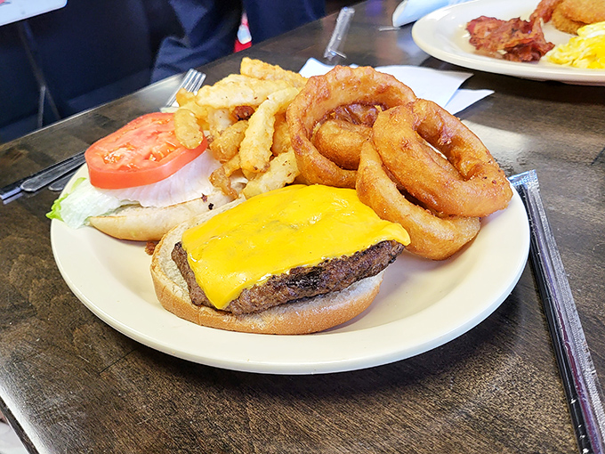 This isn't just a cheeseburger&mdash;it's a masterclass in diner perfection. Golden onion rings and crispy fries complete the holy trinity of lunch satisfaction.