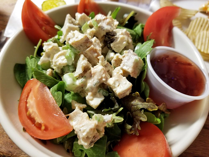 A salad that doesn't apologize for being healthy. Fresh greens, juicy tomatoes, and chicken salad that makes eating your vegetables feel like cheating.