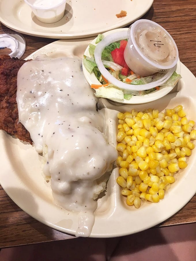 Chicken fried steak smothered in gravy with a side of corn&mdash;the kind of plate that makes you want to hug the cook and move to Oklahoma.