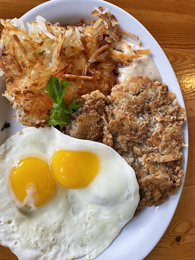The holy trinity of breakfast: perfectly cooked eggs, crispy hash browns, and chicken fried steak that could convert vegetarians to the dark side.