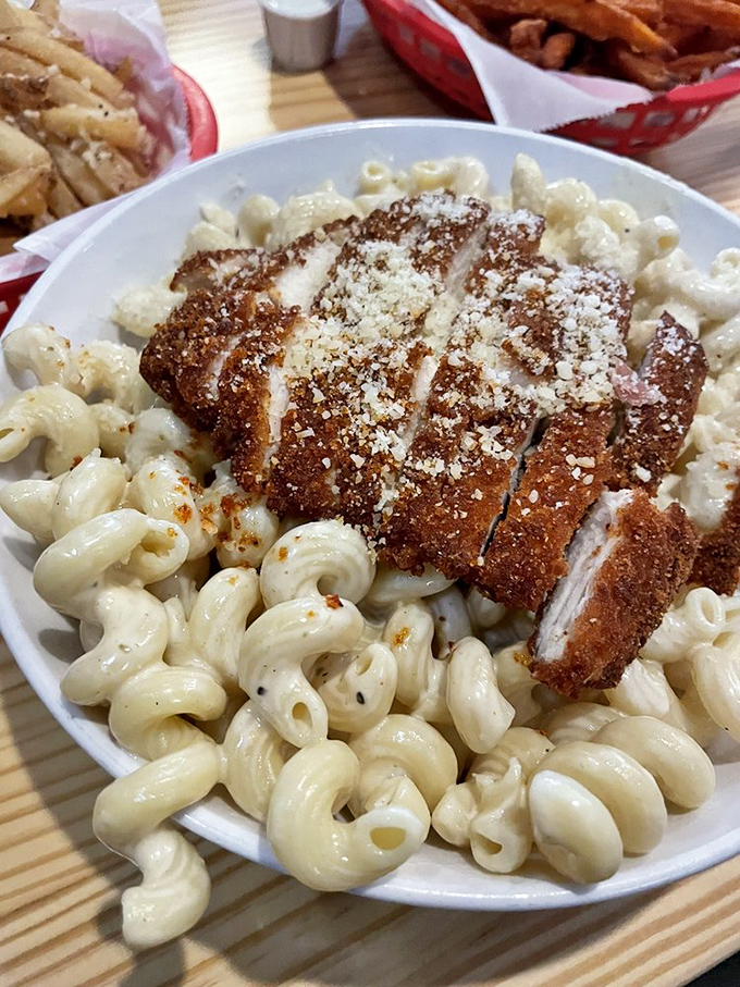 Mac 'n cheese topped with crispy chicken—comfort food having a graduate-level conversation with your taste buds.