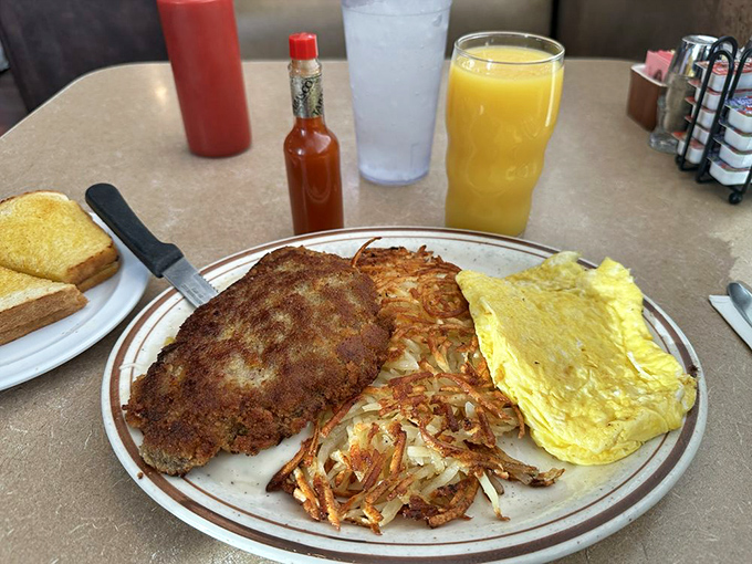 This isn't just chicken fried steak—it's armor-plated comfort on a plate, with eggs and hash browns standing by as worthy sidekicks.