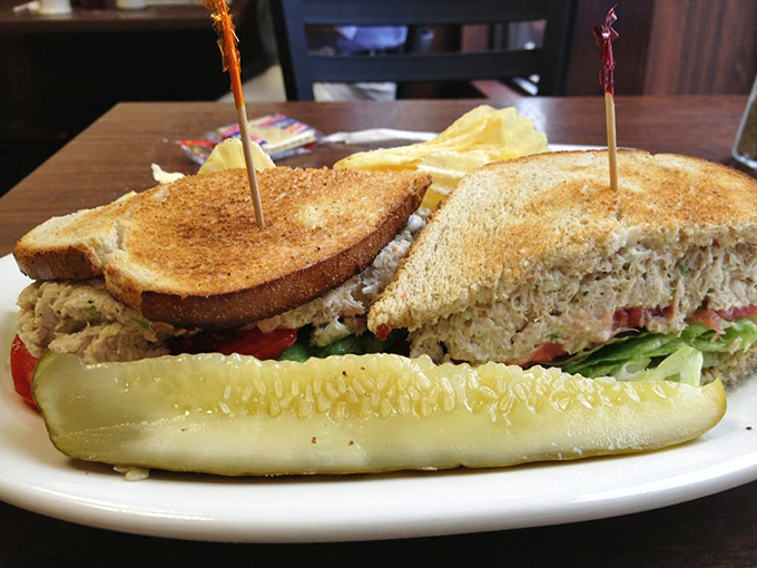 Tuna salad elevated to an art form&mdash;nestled between perfectly toasted bread with fresh veggies and a pickle spear standing guard. Lunch perfection achieved.
