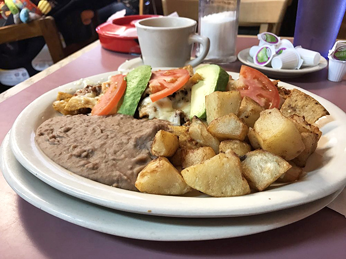 Potatoes crisped to golden perfection alongside beans and eggs—the breakfast that says "you won't need lunch today, amigo."