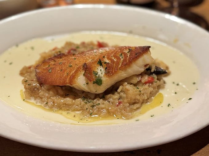 This isn't just fish&mdash;it's Chilean sea bass elevated to art form, perched atop risotto like it's posing for its own food magazine cover.