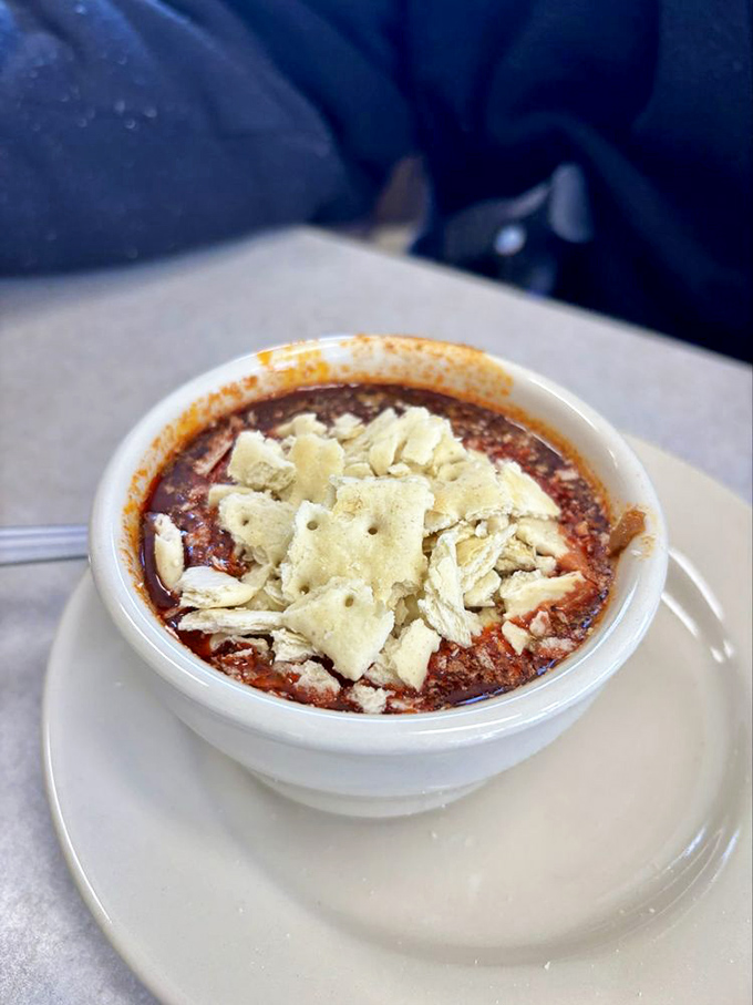A bowl of hearty chili topped with crackers&mdash;comfort food that warms you from the inside like a hug from your favorite aunt.