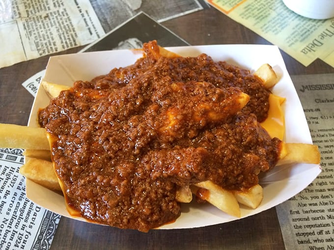 French fries transformed into a knife-and-fork affair, swimming beneath a lava flow of homemade chili that demands to be savored slowly.