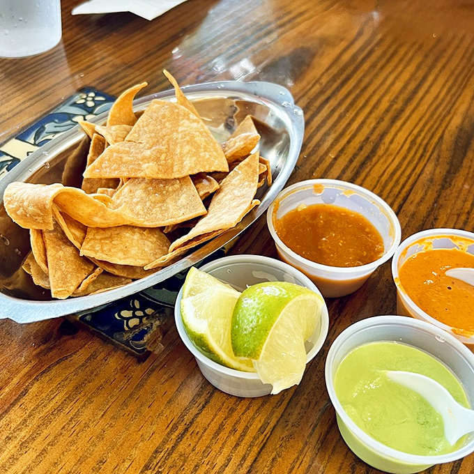 The holy trinity of Mexican starters: house-made tortilla chips, fresh lime wedges, and salsas ranging from "pleasant warmth" to "spiritual experience."