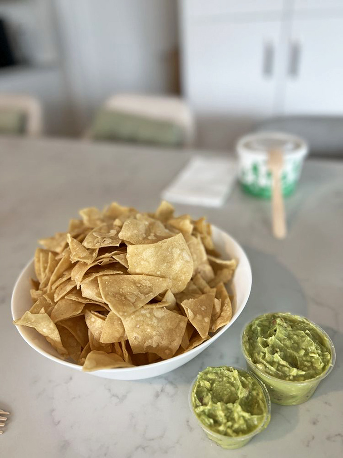 Chips and guac—the dynamic duo of appetizers—looking so fresh you can practically hear the avocados bragging about their ripeness.