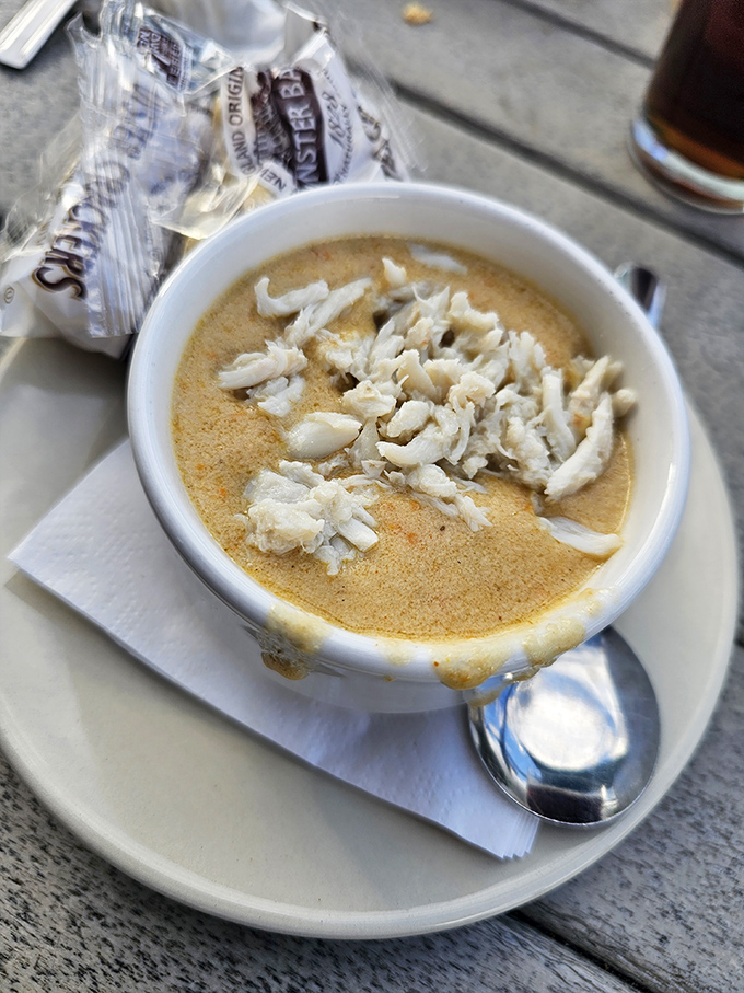 Creamy clam chowder topped with fresh crab meat transforms a simple soup into coastal comfort.