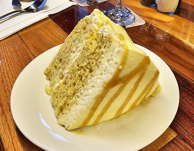 A slice of coconut cake so majestic it deserves its own ZIP code. Diet plans enter at their own risk.