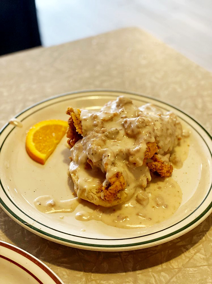 The legendary Comfy Chicken smothered in gravy that would make your grandmother both jealous and proud. That orange slice is your one nod to nutrition.