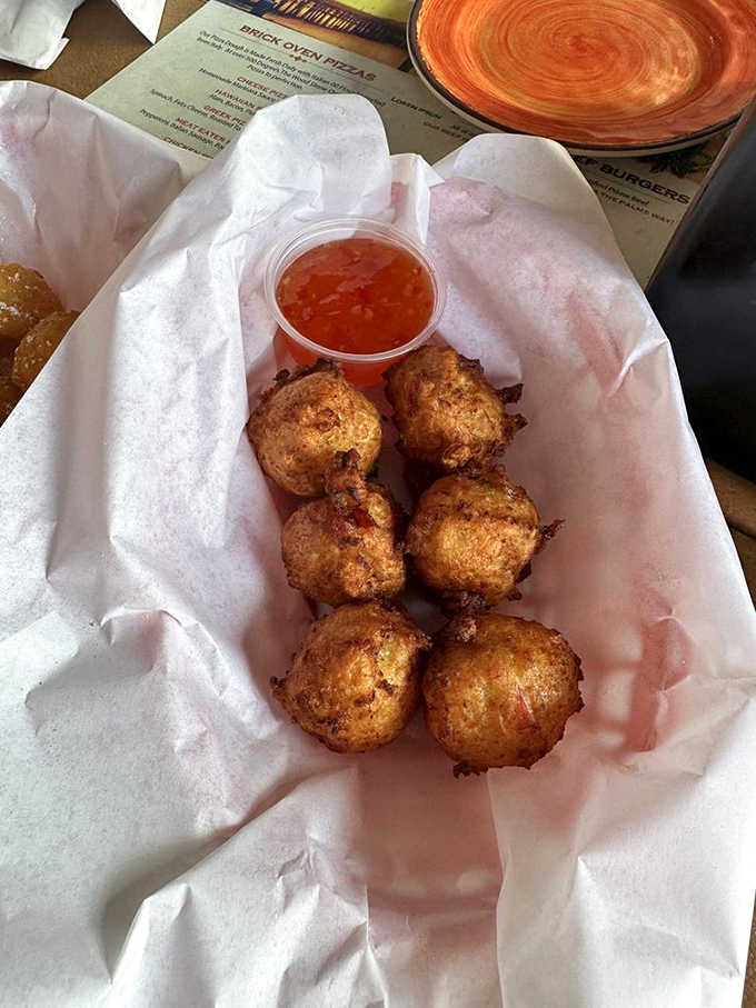 Golden-fried conch fritters that crunch like a potato chip but surprise with tender seafood inside. The perfect beer companion.